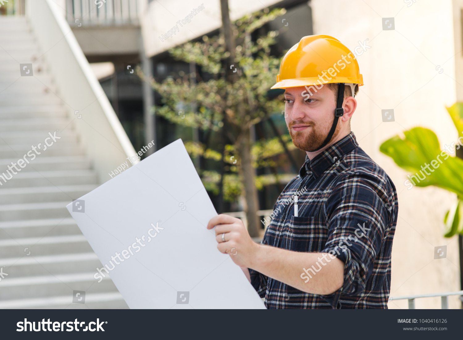 Back Engineer Holding Blueprint Building Background Stock Photo ...