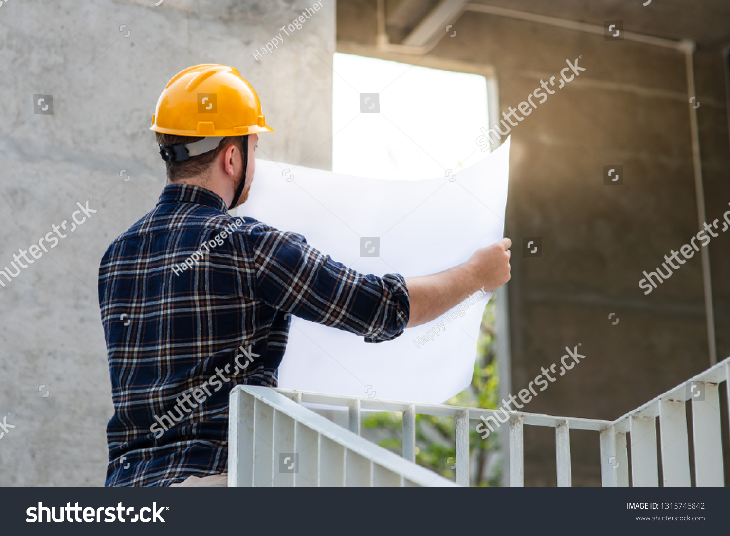 Back Engineer Holding Blueprint Building Background Stock Photo ...