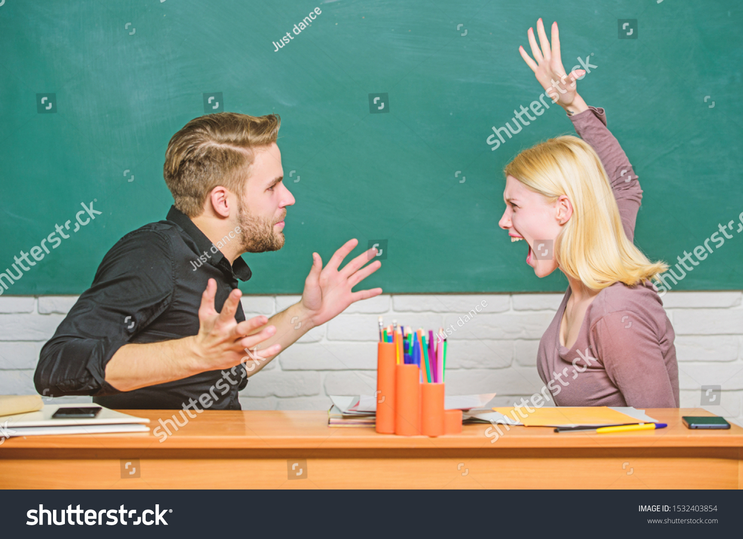 direct-opposition-couple-arguing-classroom-angry-stock-photo-1532403854