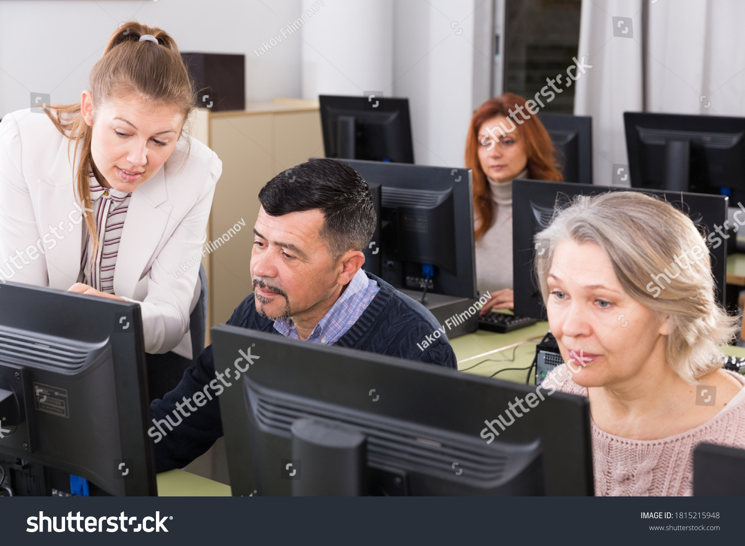 Serious Businesswoman Helping Man Pointing Computer Stock Photo ...