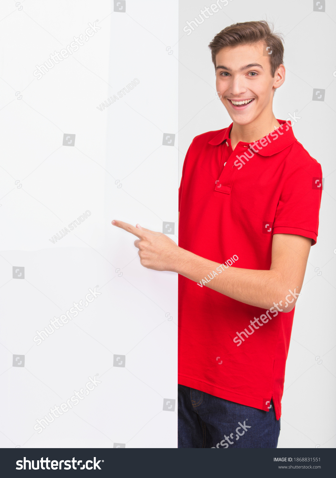 Photo Smiling Handsome White Guy Pointing Stock Photo 1868831551 ...