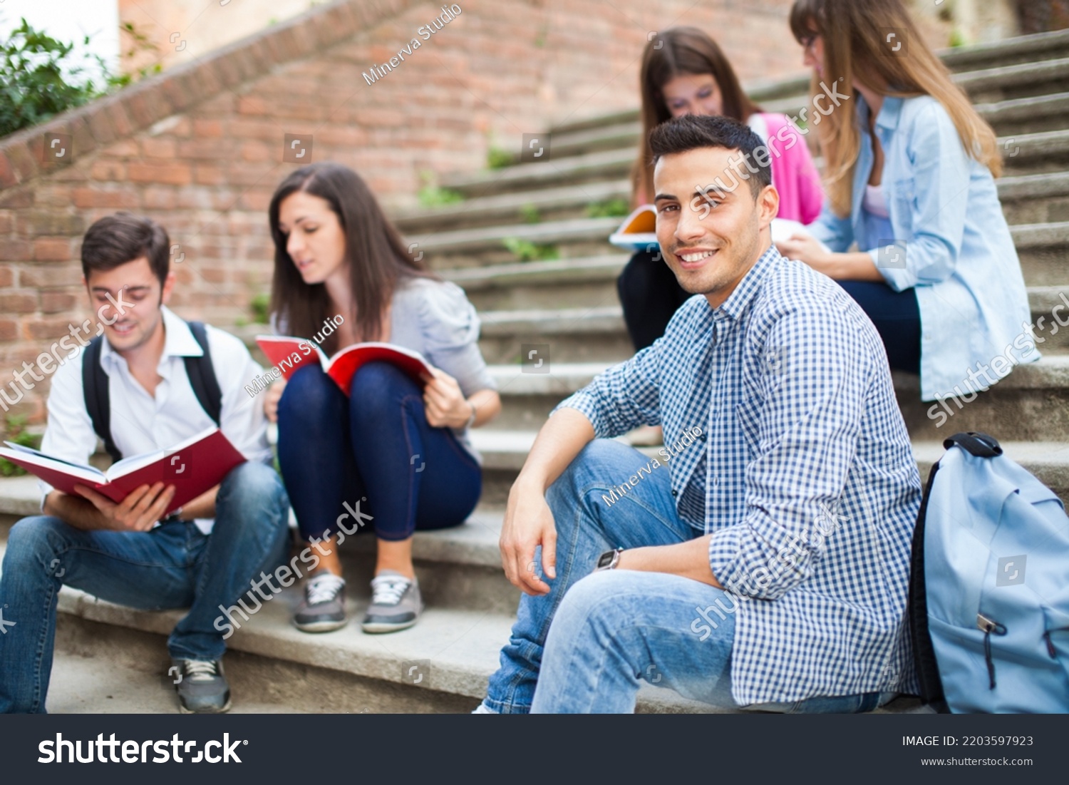 Group Smiling Students Sitting On Staircase Stock Photo 2203597923 ...
